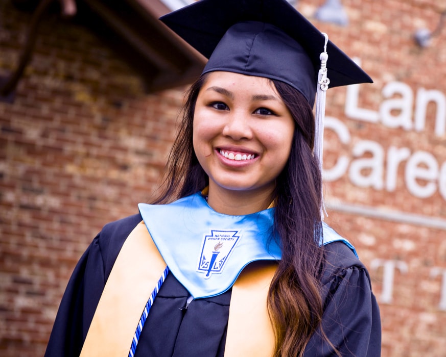 Female high cchool graduate in cap and gown | Goodwill Industries of ...